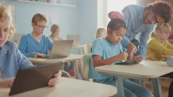Elementary School Computer Science Class: Cute Girl Uses Digital Tablet ...