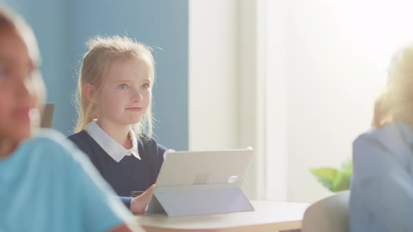 Elementary School Computer Science Class: Cute Girl Uses Digital Tablet ...