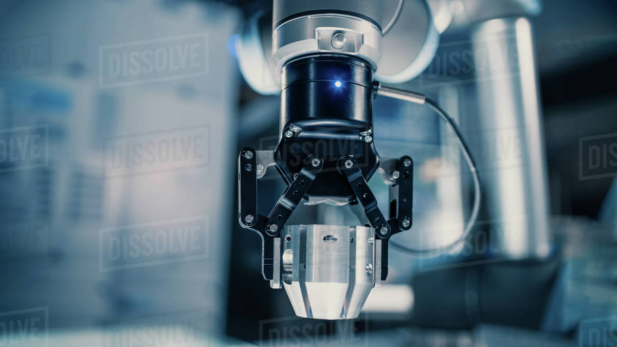 Close Up of a Futuristic Robotic Arm Moving a Metal Object and Placing ...