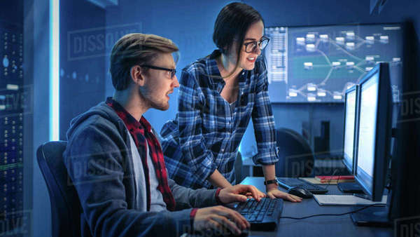 Male and Female Programmers Talking, Solving Problem, Using Computers ...