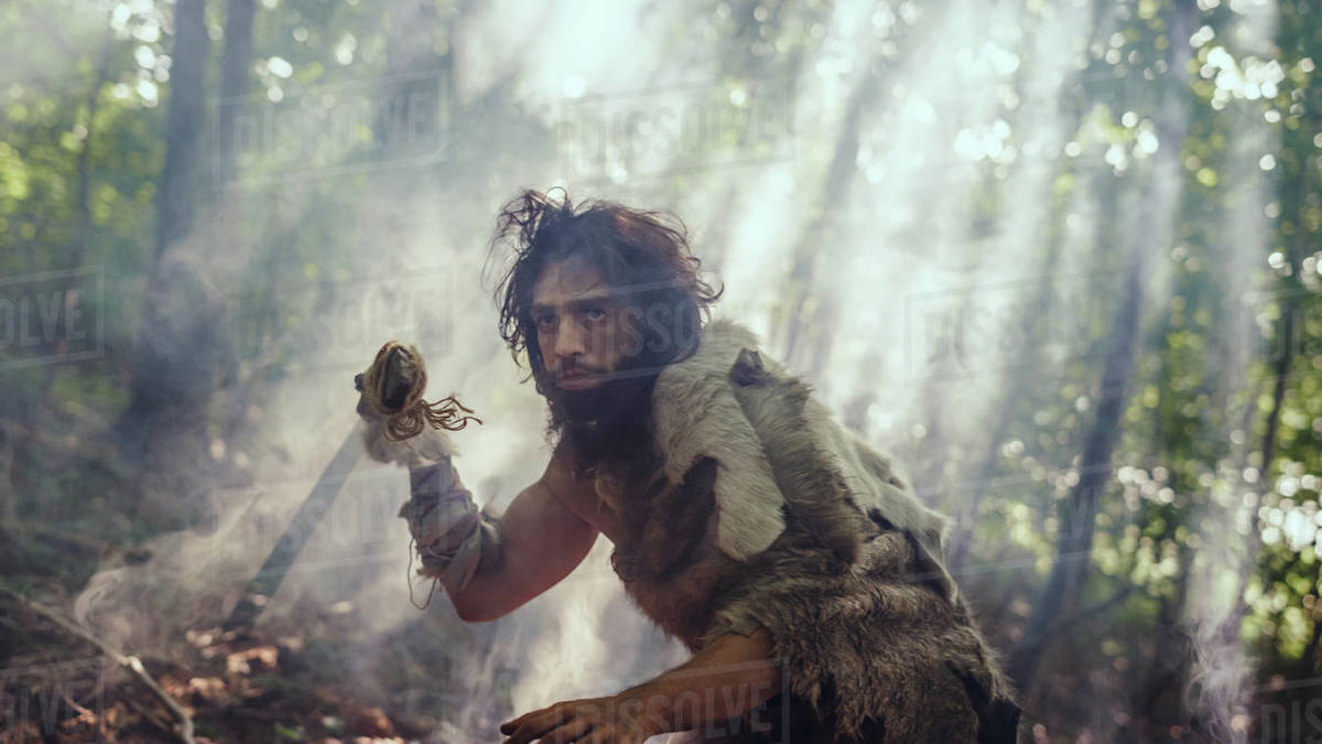 Portrait of Primeval Caveman Wearing Animal Skin and Fur Hunting with a ...