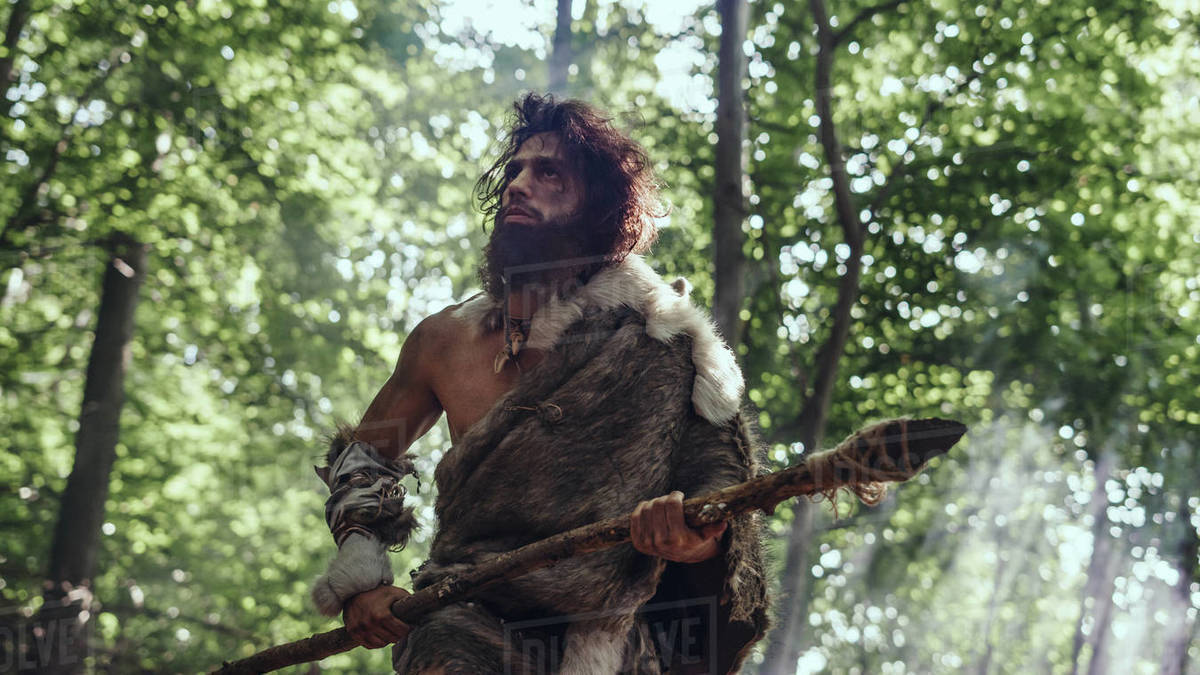 Portrait of Primeval Caveman Wearing Animal Skin and Fur Hunting with a ...