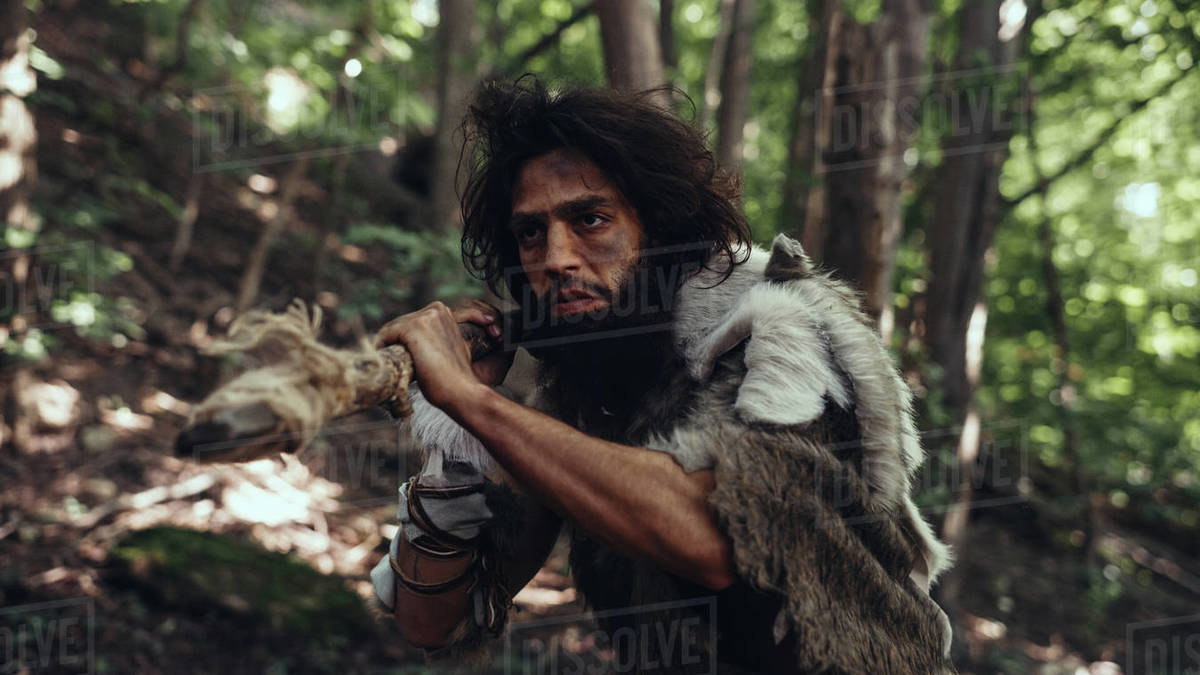 Portrait of Primeval Caveman Wearing Animal Skin and Fur Hunting with a ...