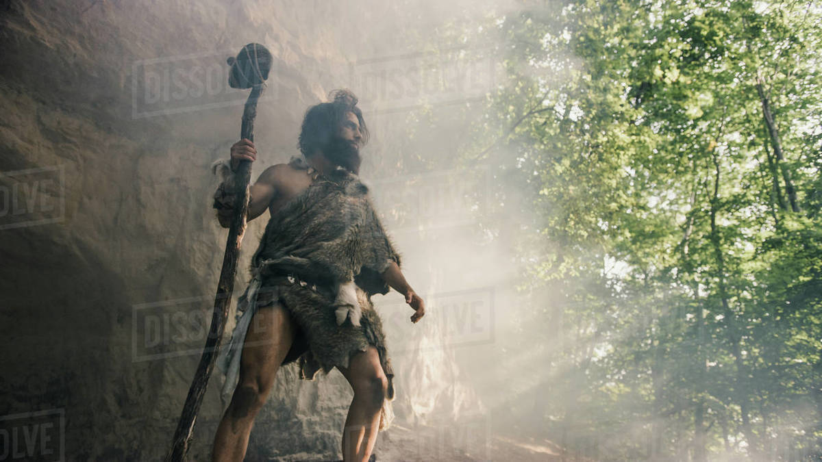 Primeval Caveman Wearing Animal Skin Holds Stone Hammer Stands Near ...