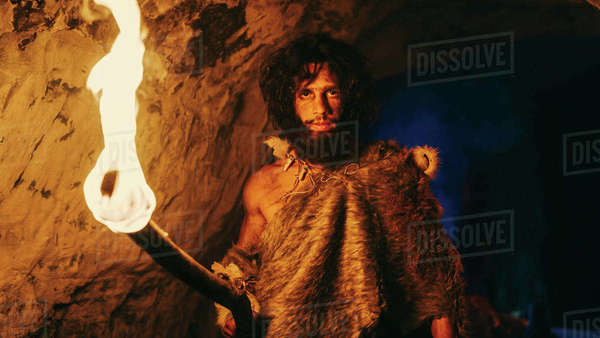 Portrait of Primeval Caveman Wearing Animal Skin Exploring Cave At ...