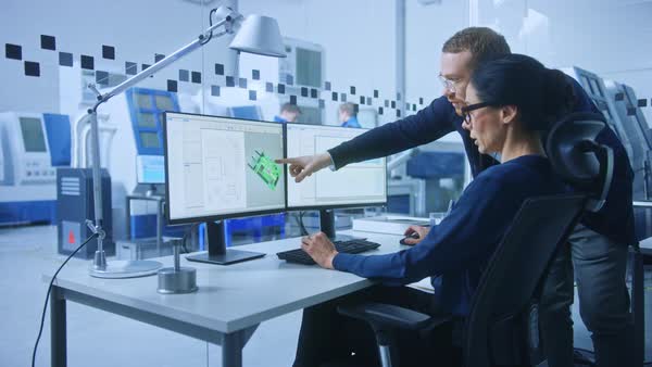 Modern Electronics Factory: Male Supervisor Talks to a Female ...