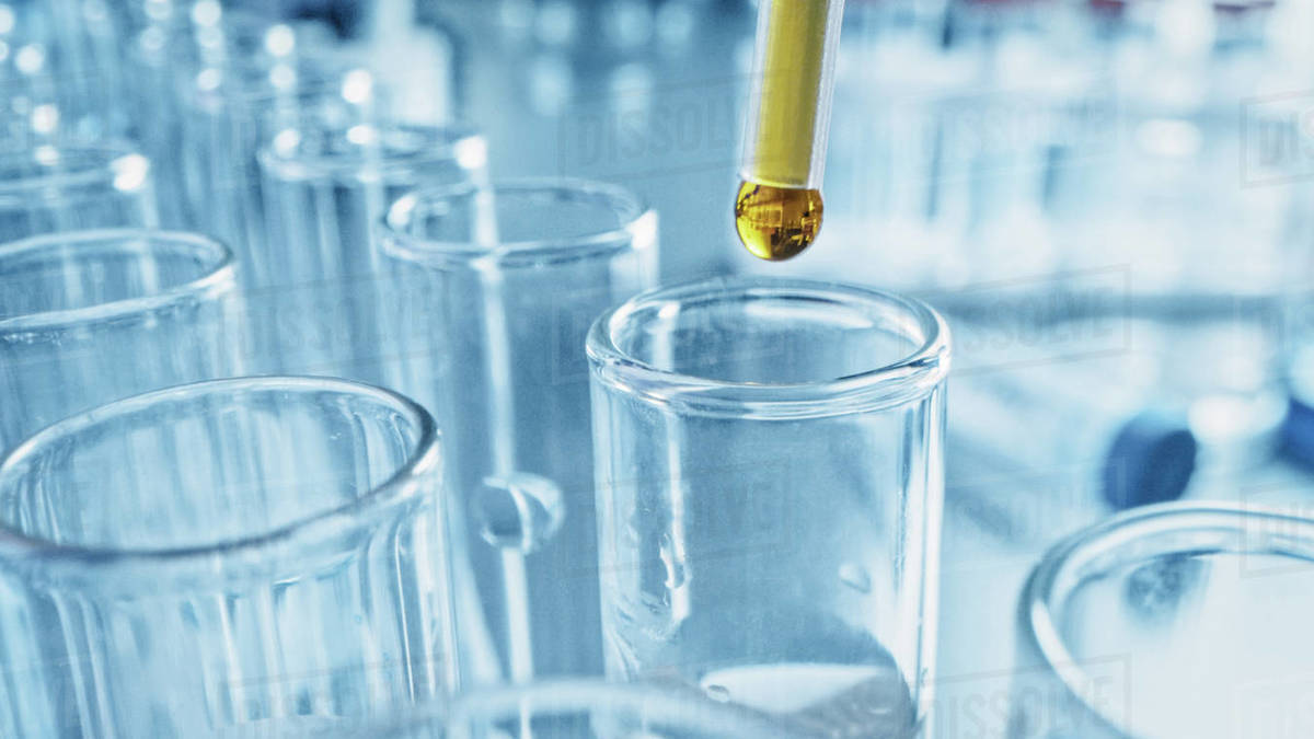 Pharmaceutics Laboratory: Pipette Dropping Yellow Liquid into Test ...
