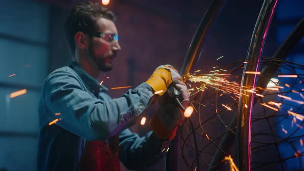 Young Contemporary Artist is Grinding His Metal Tube Sculpture with a ...