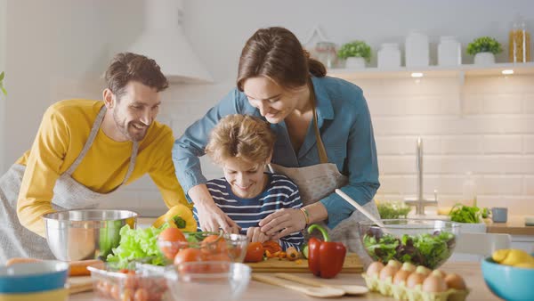 In Kitchen: Family of Three Cooking Together Healthy Dinner. Mother and ...