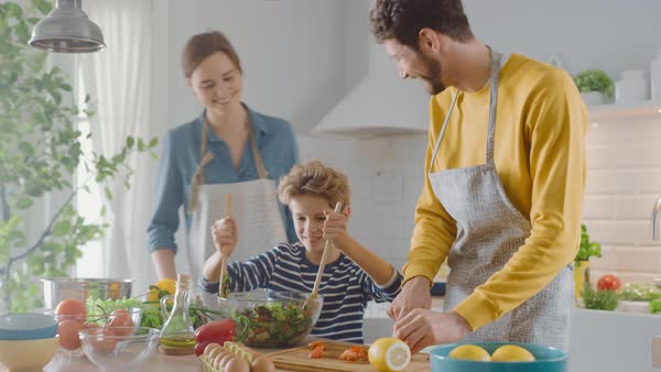 In the Kitchen: Mother, Father and Cute Little Boy Cooking Together ...