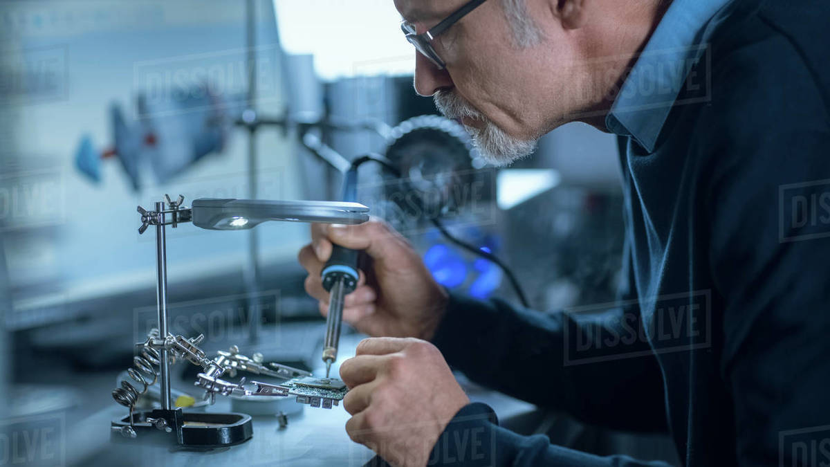 Portrait of Focused Middle Aged Engineer in Glasses Working with High ...