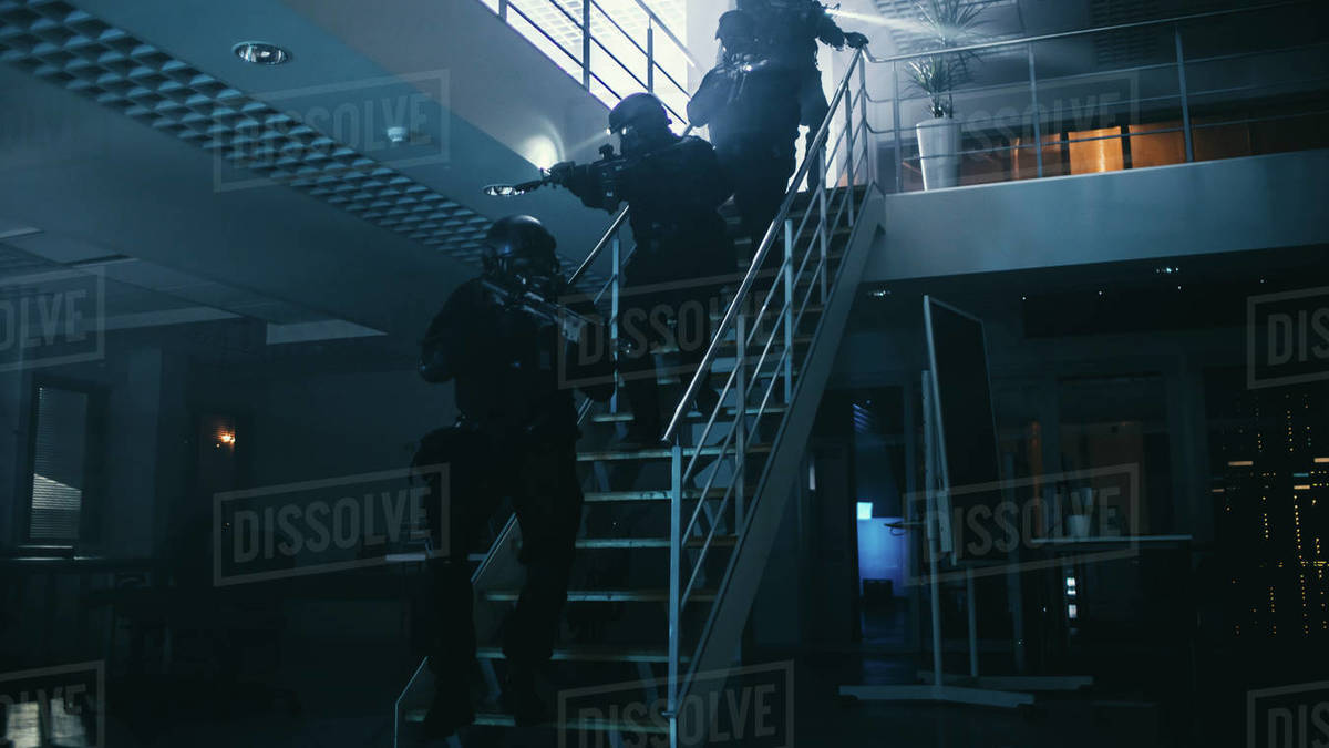 Masked Squad of Armed SWAT Police Officers Run Down the Stairs from a ...
