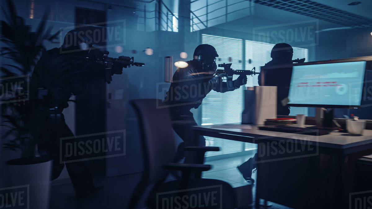 Masked Squad of Armed SWAT Police Officers Move in a Hall of a Dark ...