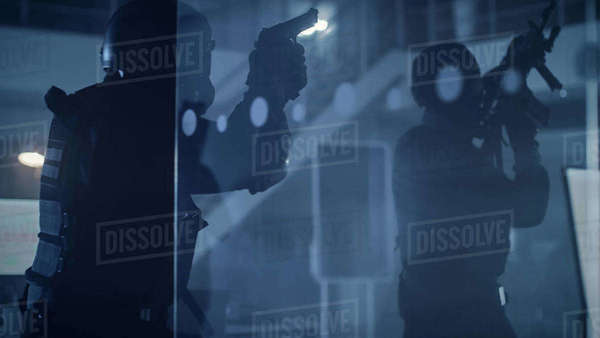Masked Team of Armed SWAT Police Officers Move in a Hall of a Dark ...