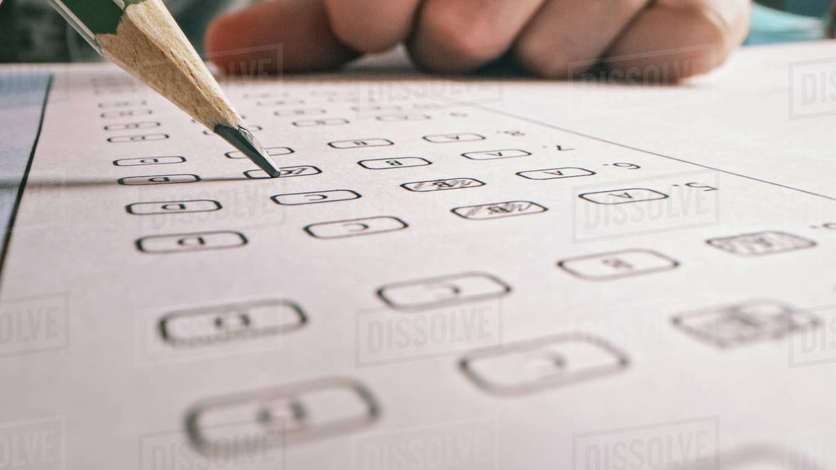 On Exam Test Person Colors Right Answers with a Pencil. Filling up ...