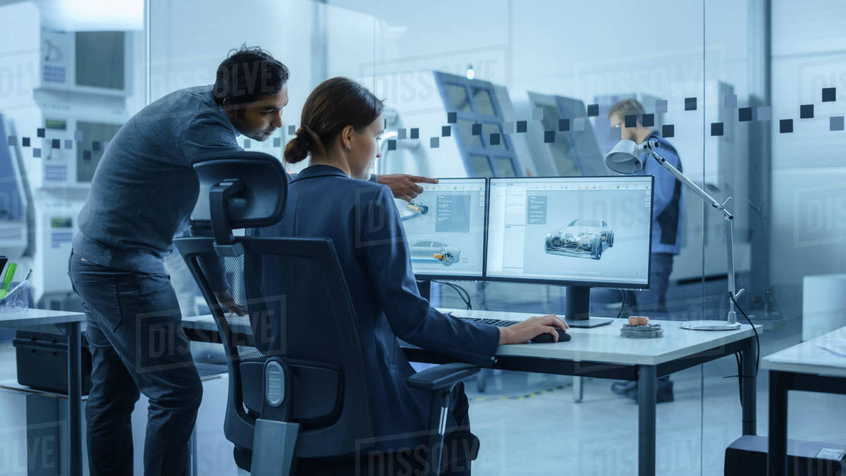 Automotive Design Factory: Project Manager and Chief Mechanical Engineer Talk, Point at Computer ...