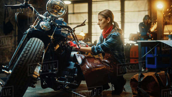 Young Beautiful Female Mechanic is Working on a Custom Bobber ...