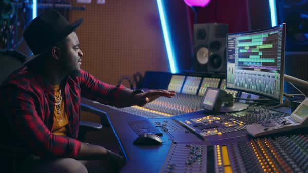 Stylish Audio Engineer Working in Music Recording Studio, Uses Mixing ...