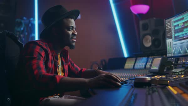 Energetic Audio Engineer / Producer Working in Music Recording Studio ...