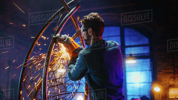 Shot of Talented Innovative Artist Using an Angle Grinder to Make an ...
