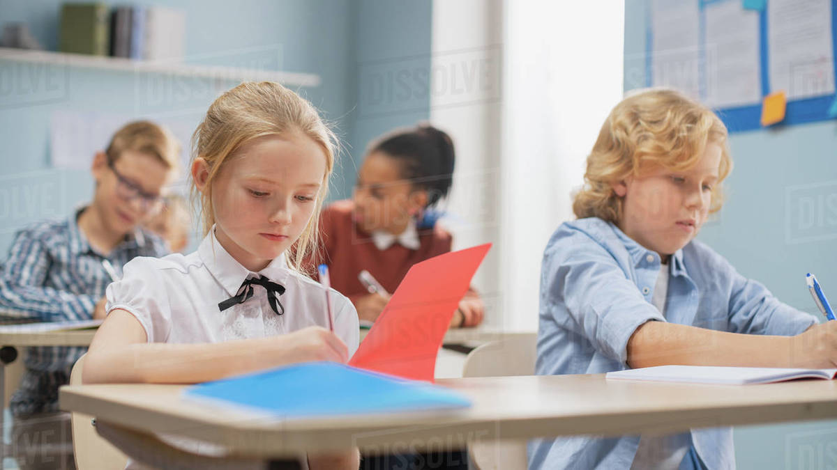 Elementary Classroom of Diverse Bright Children Listening Attentively ...