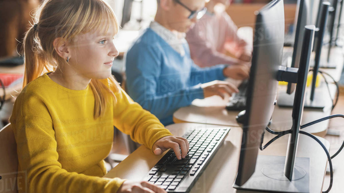 Elementary School Computer Science Classroom: Cute Little Girl Uses ...