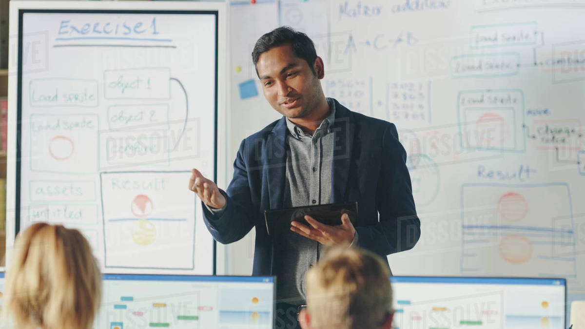 Elementary School Class: Teacher Uses Interactive Digital Whiteboard, Explains Lesson to Diverse ...