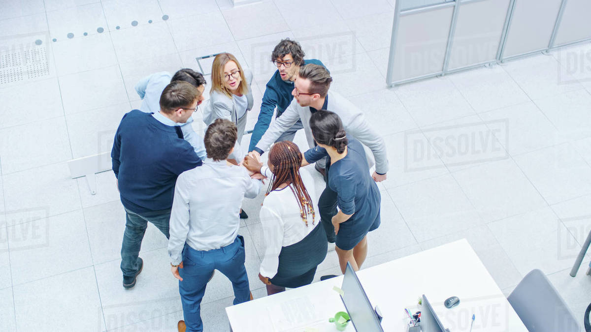 Eight Successful Office Workers doing Team Building Exercise Stacking ...