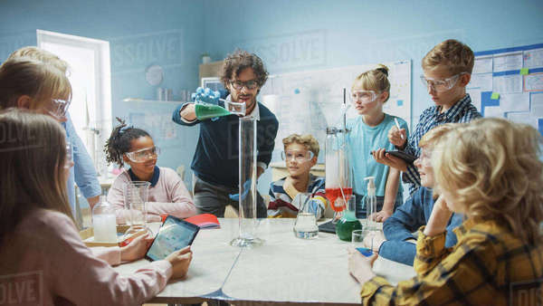 Elementary School Science / Chemistry Classroom: Teacher Shows Chemical ...