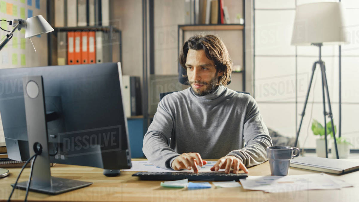 Creative Entrepreneur Sitting at His Desk Works on Desktop Computer in ...