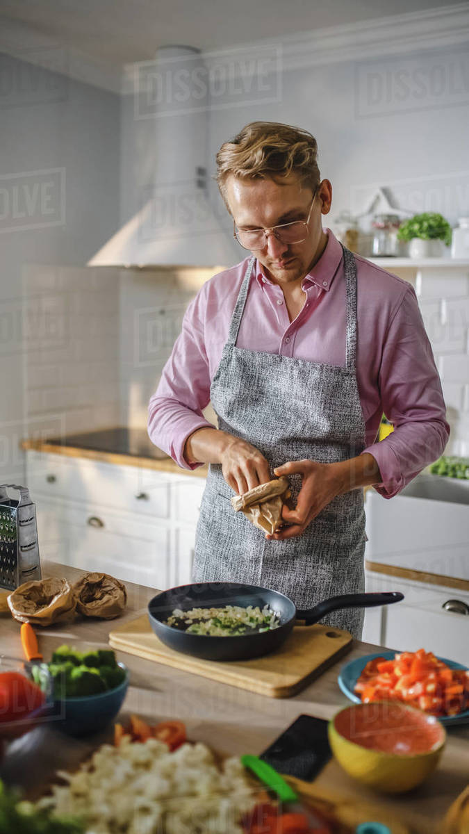 Handsome Young Man Preparing a Healthy Vegetarian Meal on a Frying Pan ...