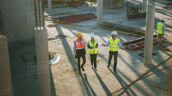 Diverse Team of Specialists Taking a Walk Through Construction Site ...