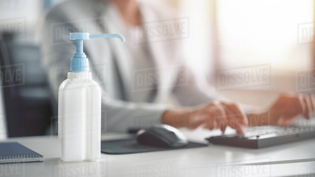 Hand sanitizer on work desk - Royalty-free Stock Photo | Dissolve