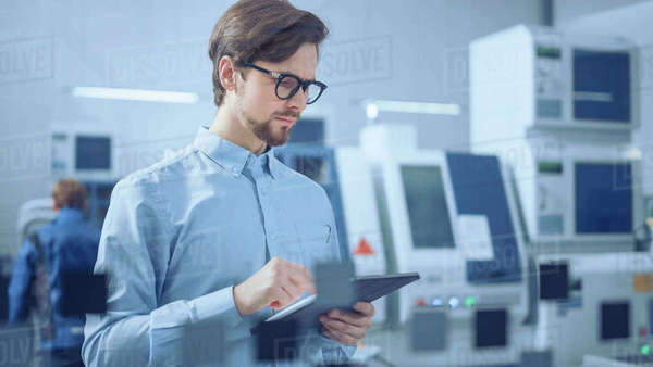 Modern Factory: Industrial Engineer Standing in Facility Workshop ...