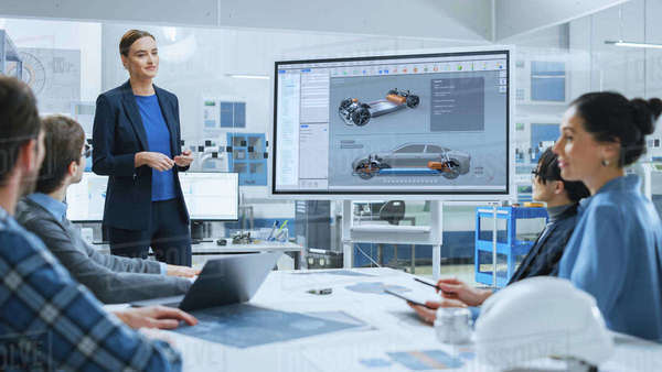Confident Female Automotive Engineer Reports to Diverse Team of ...