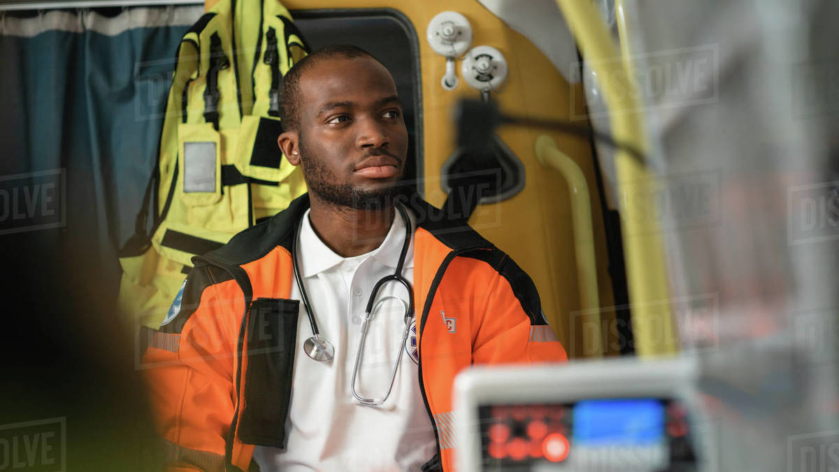 A shot of a Paramedic Riding in an Ambulance - Royalty-free Stock Photo ...