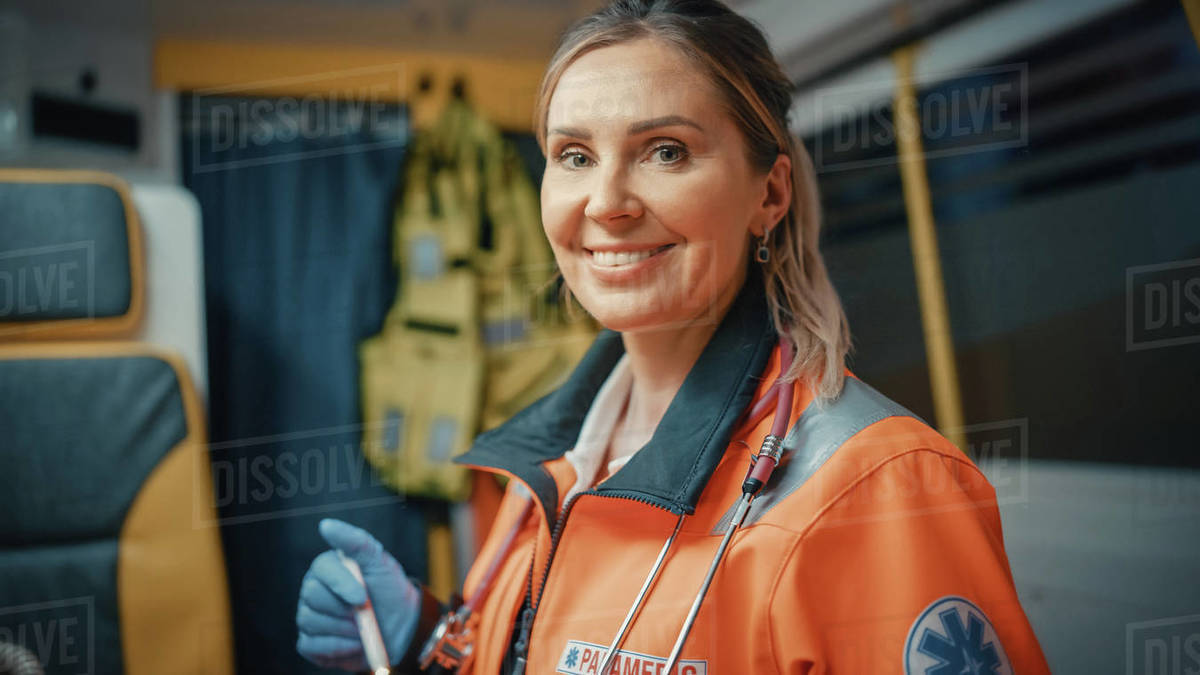 Calm Female EMS Smiles on Camera in Ambulance - Royalty-free Stock ...