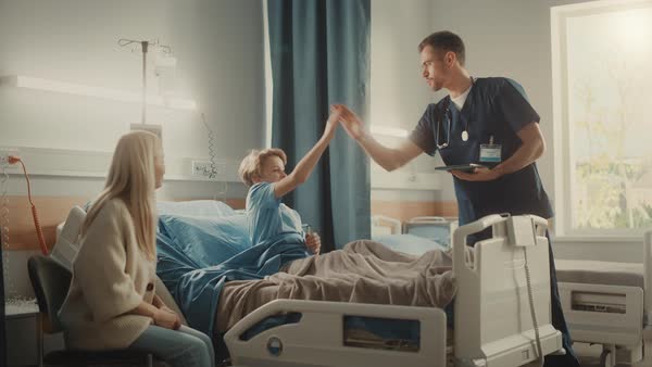 Hospital Ward: Handsome Young Boy Resting in Bed with Caring Mother ...