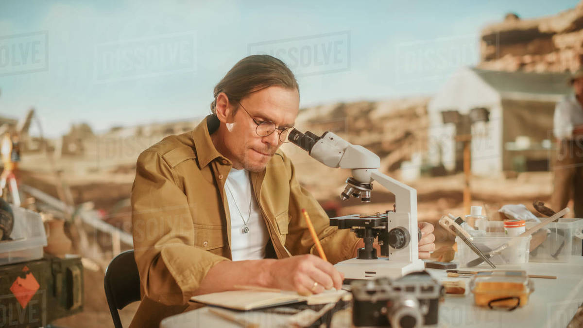 Male Archaeologist Doing Research - Stock Photo - Dissolve