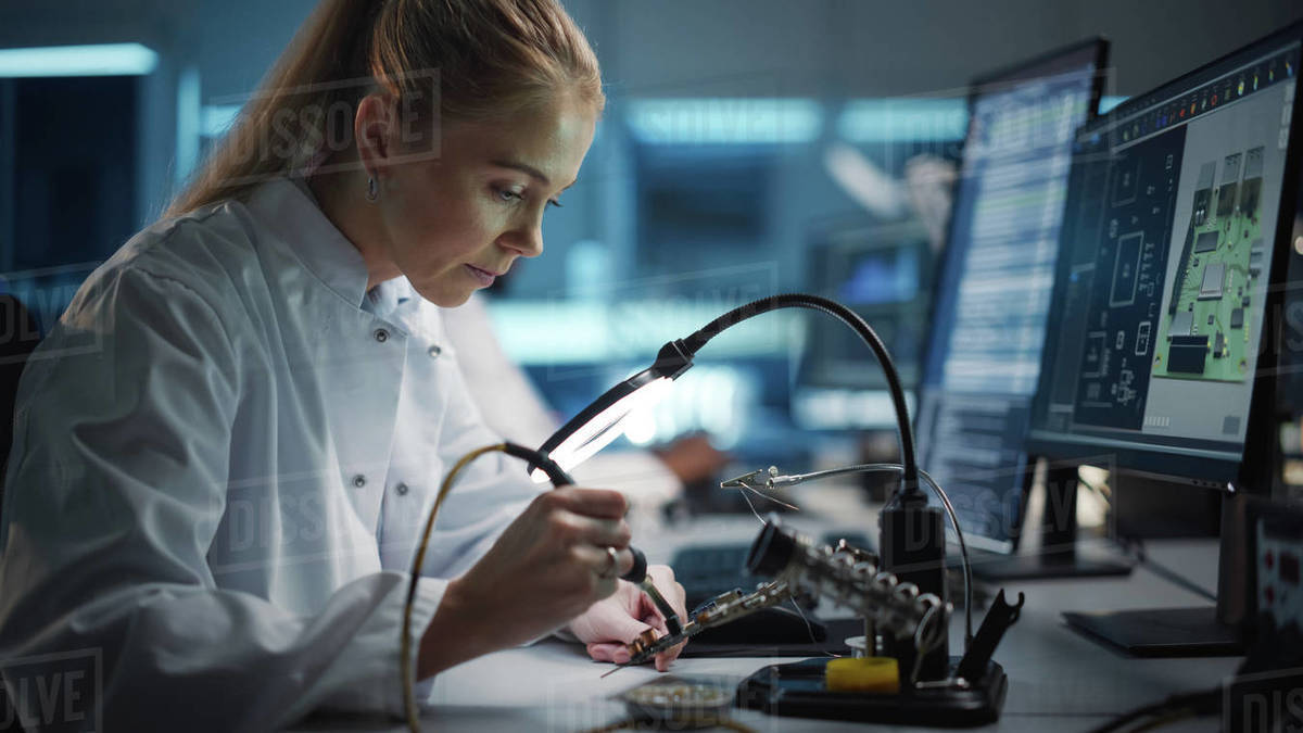 Caucasian Female Engineer Does Computer Motherboard Soldering - Royalty ...