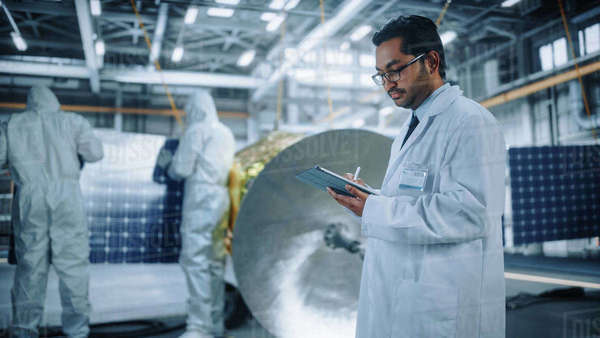 Team of Engineers Working on Satellite Construction, Scientist Uses ...