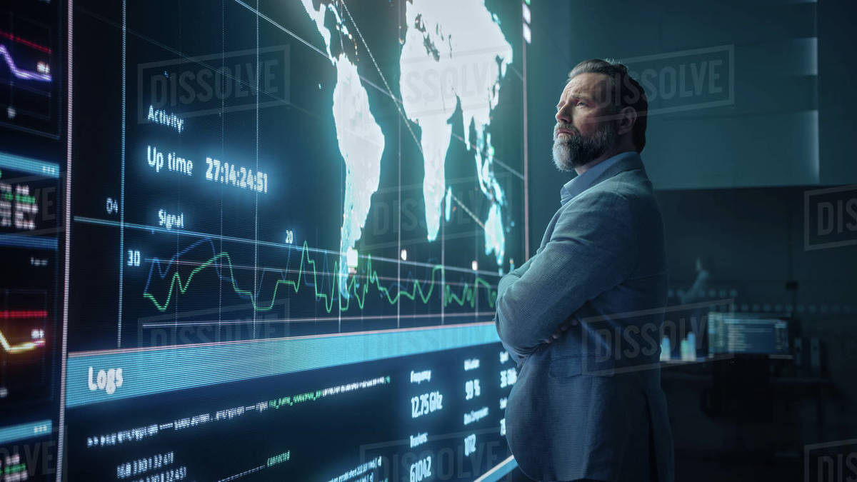 Senior Computer Science Engineer Looking at Big Screen Display Showing Global Map with Data ...