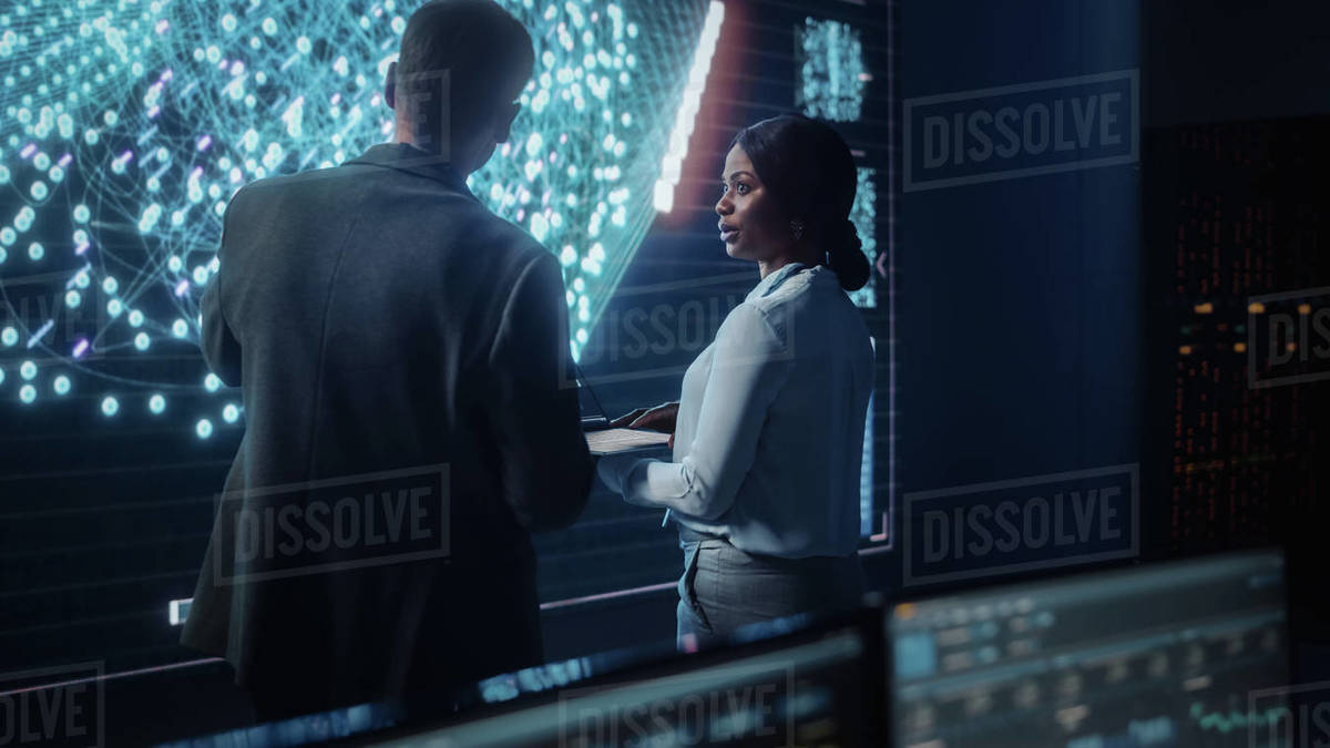 Project Manager and Computer Science Engineer Talking while Using Big Screen Display Showing ...