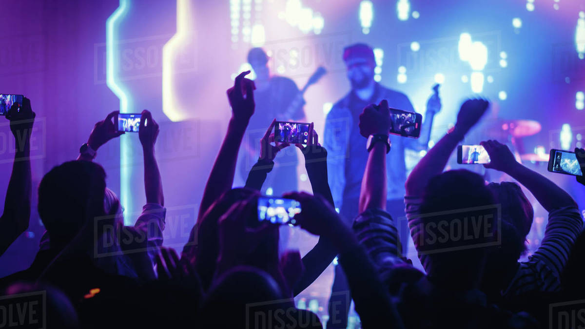 Rock Band with Guitarists and Drummer Performing at a Concert in a ...