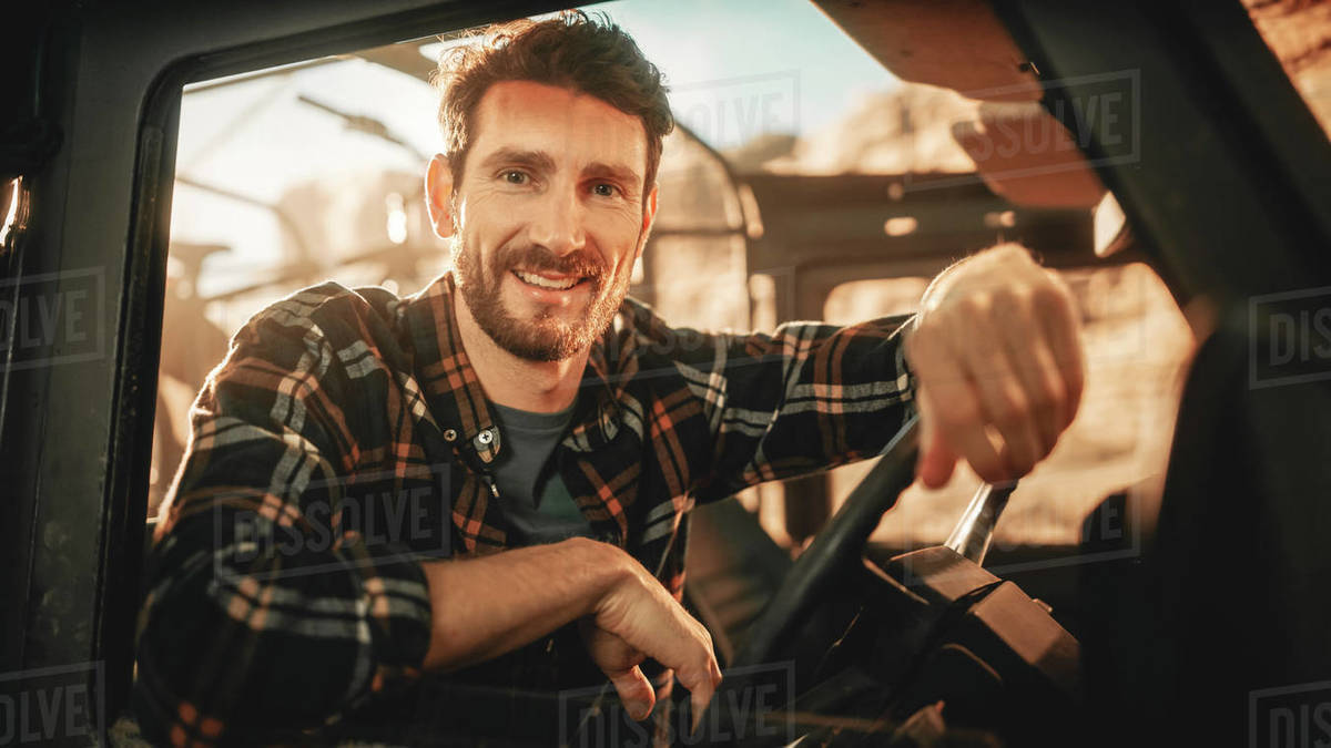 Desert Road Trip: Portrait of Handsome Male Explorer Looking out of Car ...