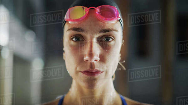 Beautiful Professional Female Swimmer in Swimming Pool, Wearing Cap ...