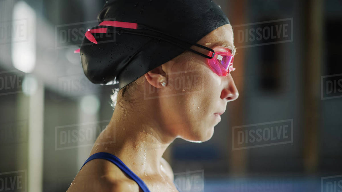 Beautiful Professional Female Swimmer in Swimming Pool, Wearing Cap ...