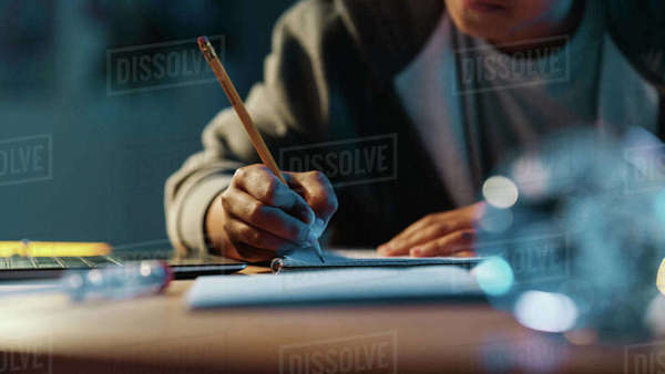 Close up of a Teenage Girl Writing Down Homework in a Notebook with a ...
