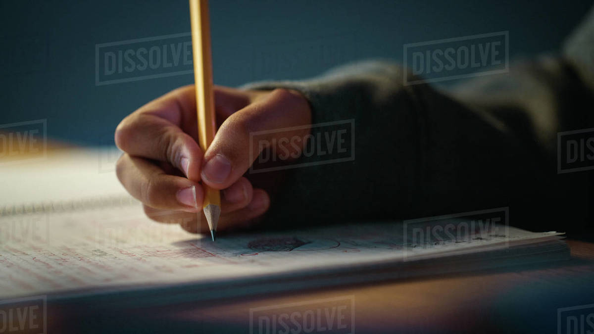 Close Up Shot of a Young Person Writing with Pencil in Notebook - Stock ...