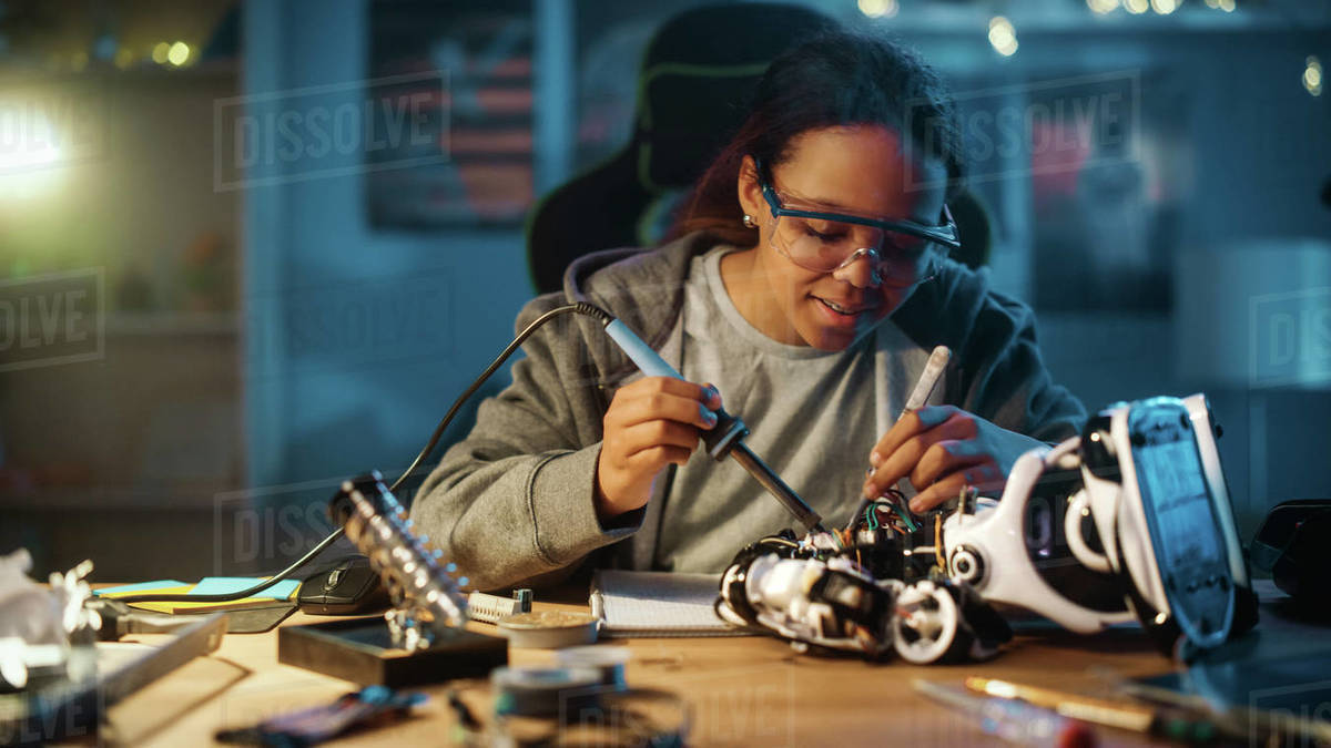 Young Teenage Schoolgirl is Studying Electronics and Soldering Wires ...